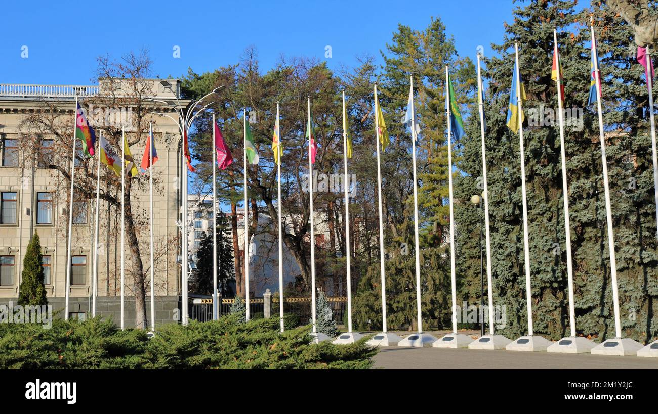 tall flagpoles with multi-colored flags of different regions of the ...