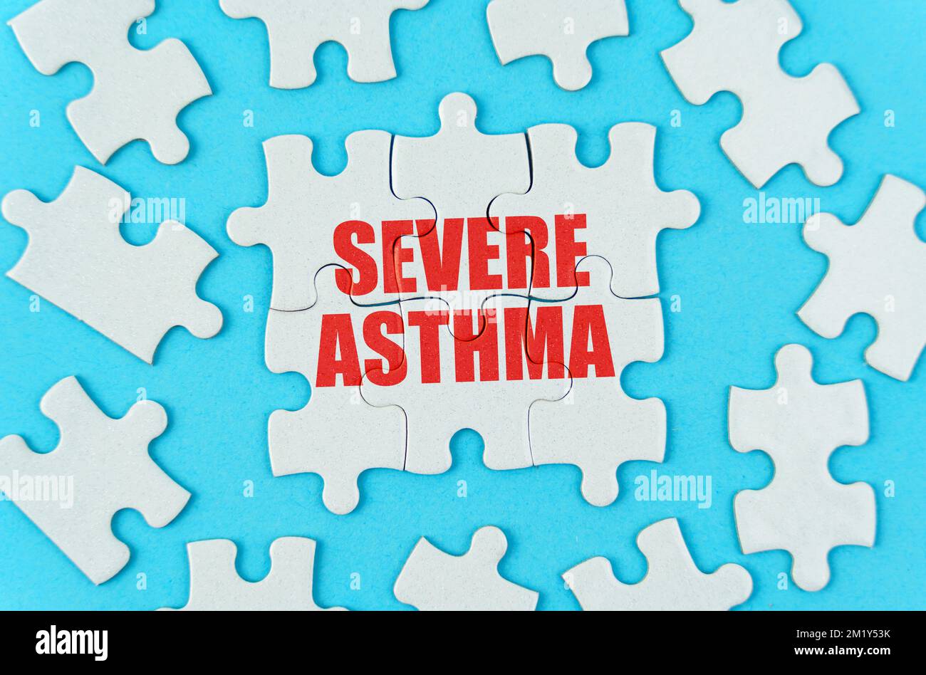 Medical concept. On a blue background are white puzzles with the ...