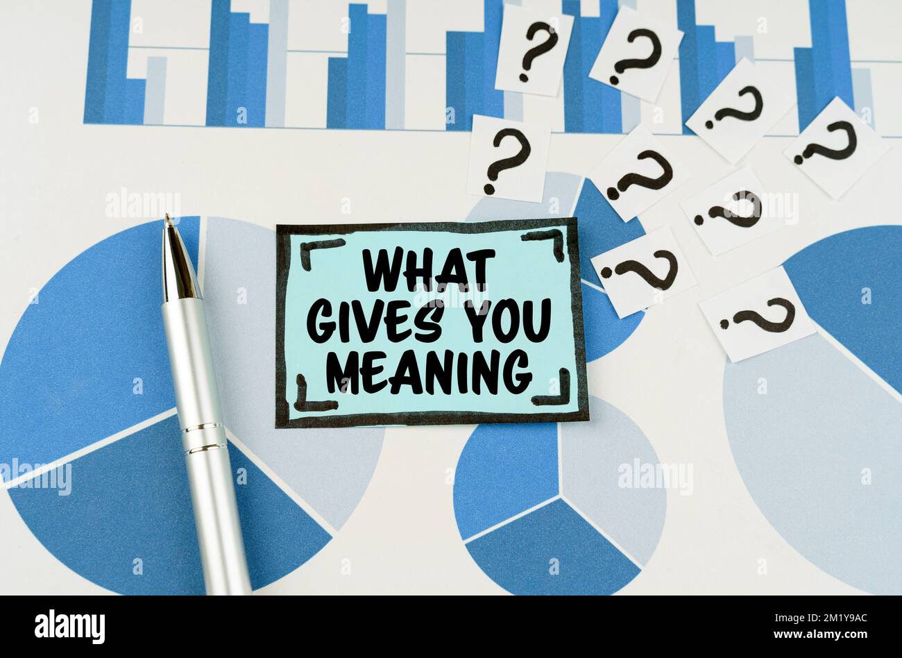business question concept. On the blue diagrams lies a pen, questions ...