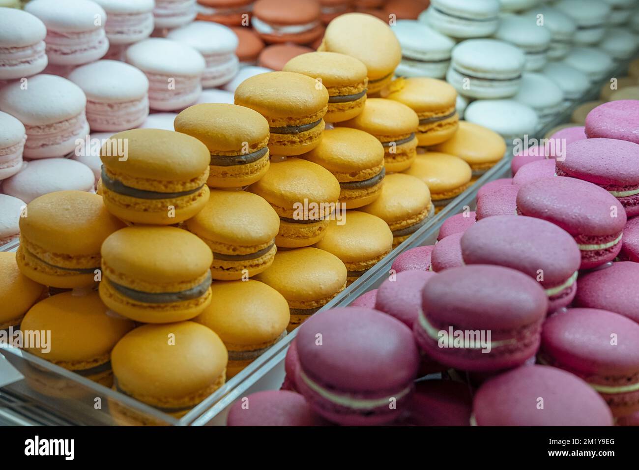 Variety of macarons or macaroons displayed in a coffee shop window ...