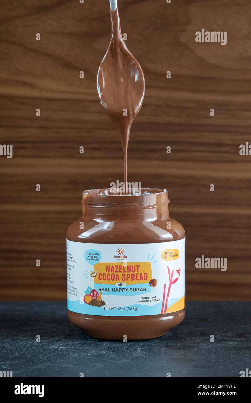Spoon dripping with chocolate spread created by DouxMatok using an ...