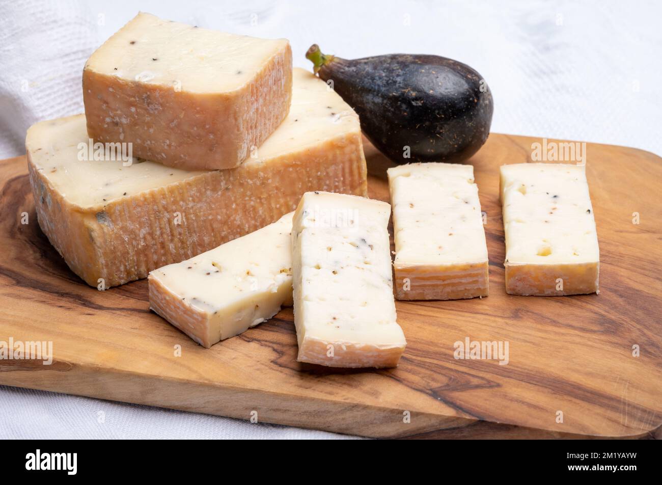 Italian cheese collection, yellow taleggio cheese with black truffles ...