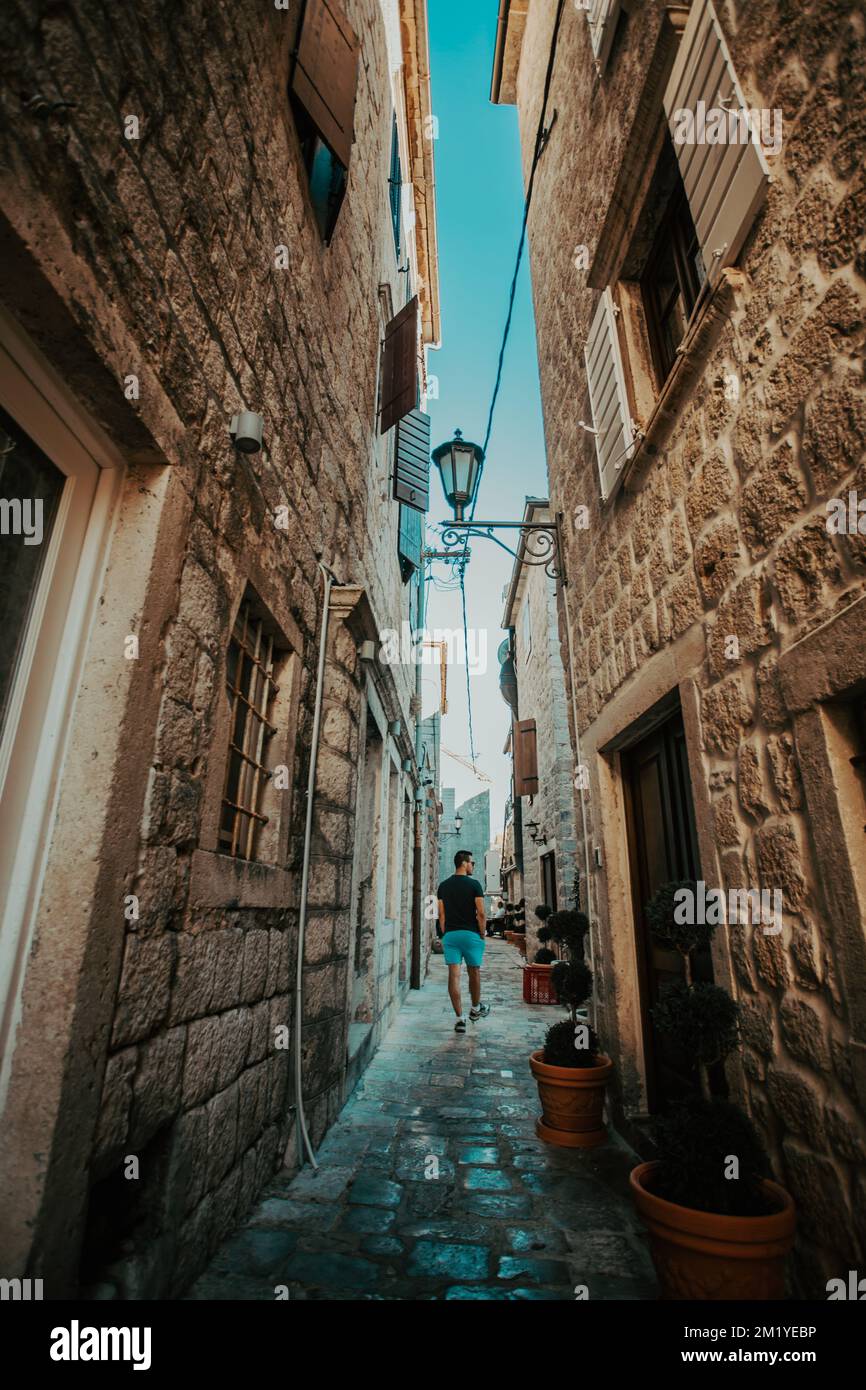 Man walking between buildings hi-res stock photography and images - Alamy