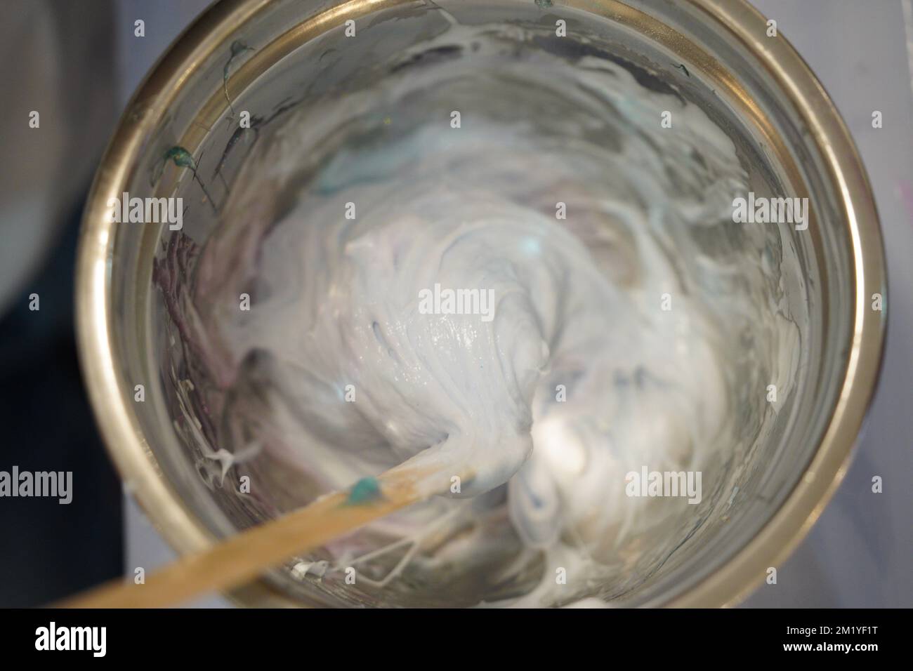 kid making slime adding glitter glue and white glue mixing it with ...