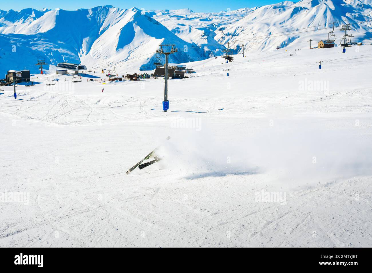 Dynamic picture of a skier on the piste in Alps fall down hard in snow ...