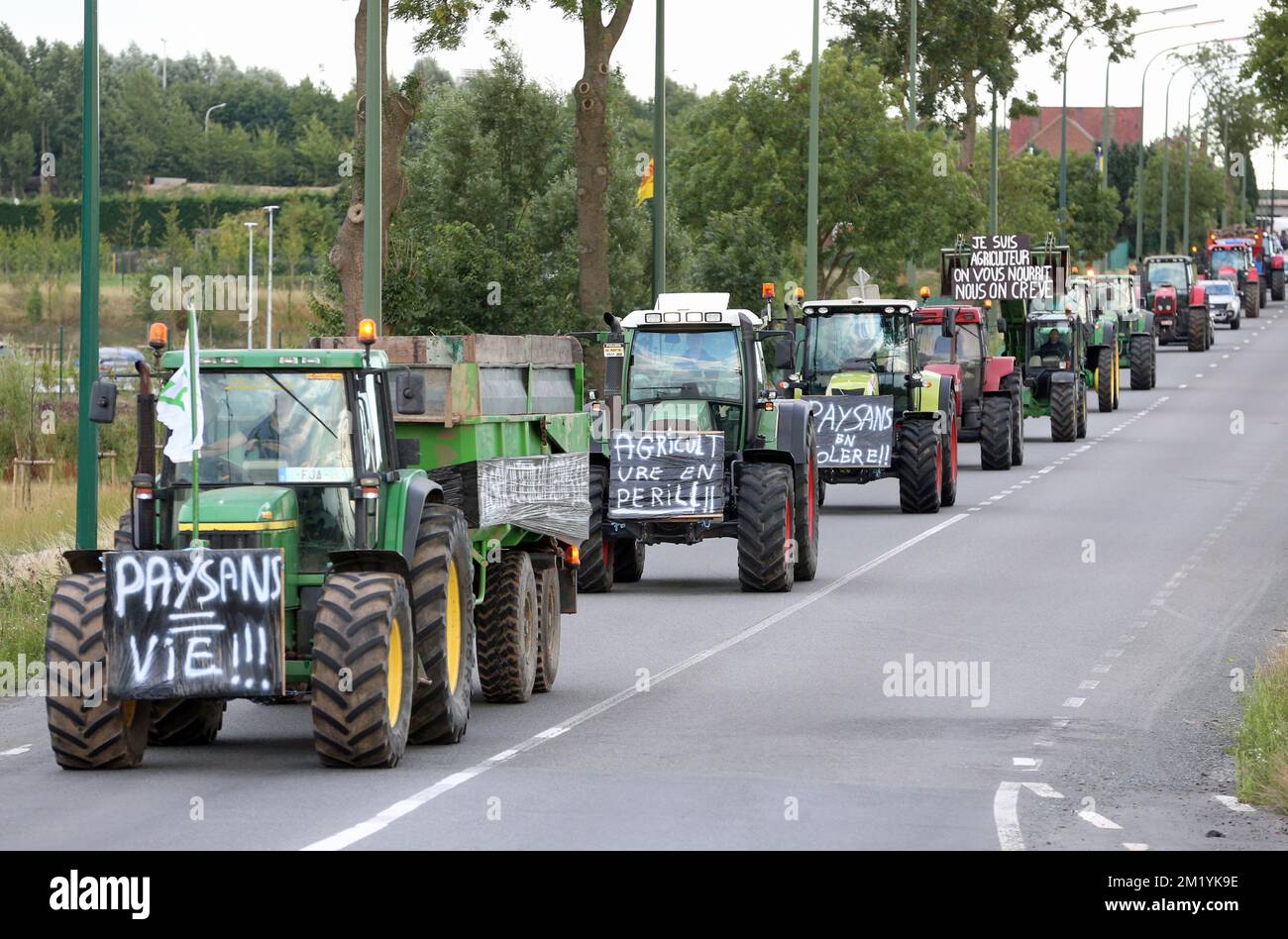 Tractors with signs pictured on the road, a protest action of dairy ...
