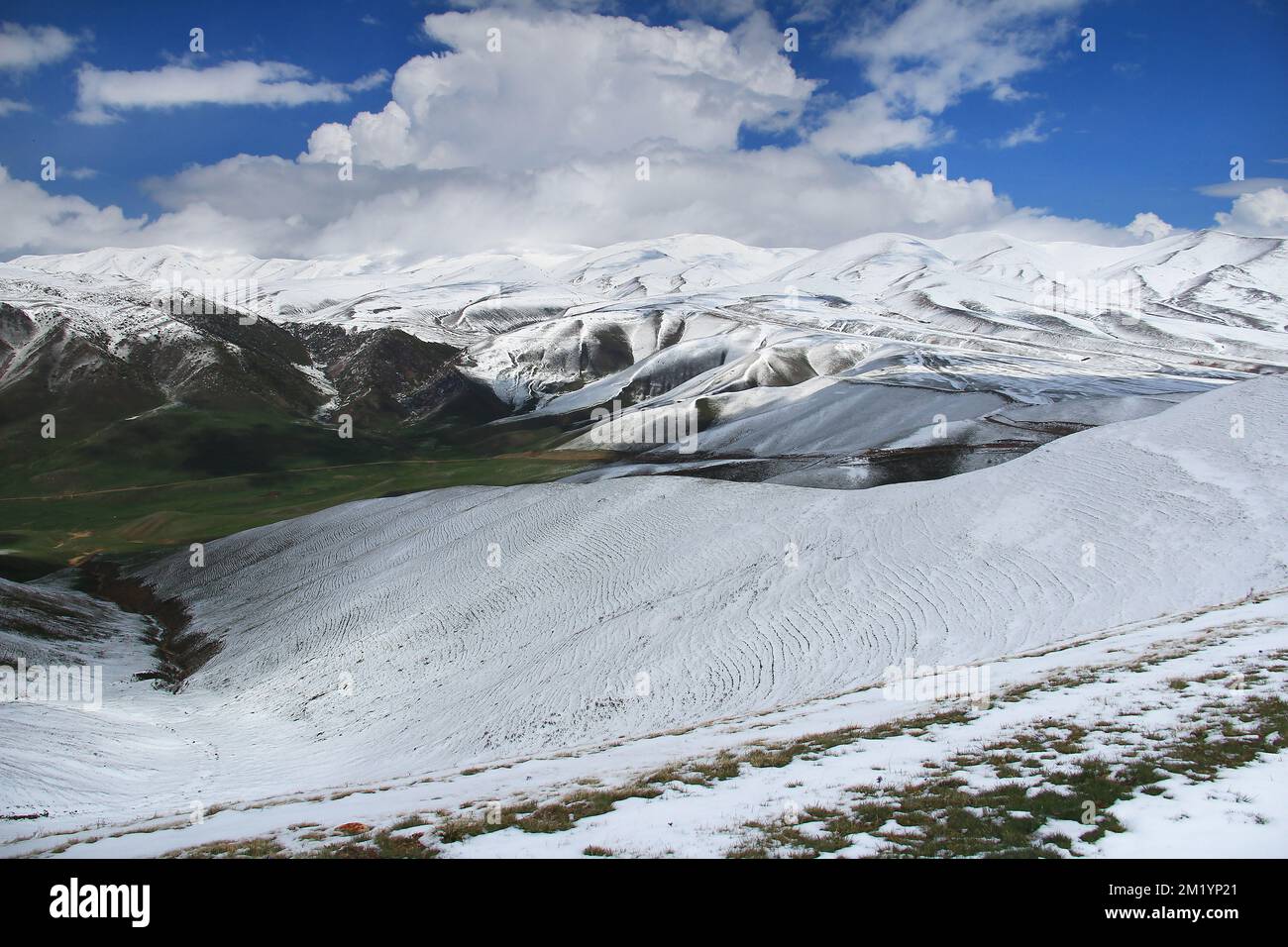 Snow-covered mountain ranges on the Assy plateau against the background ...