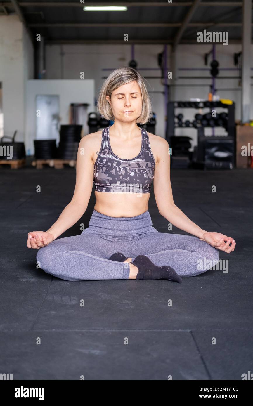 Vertical photo of a smiley and relaxed mid adult woman resting and ...