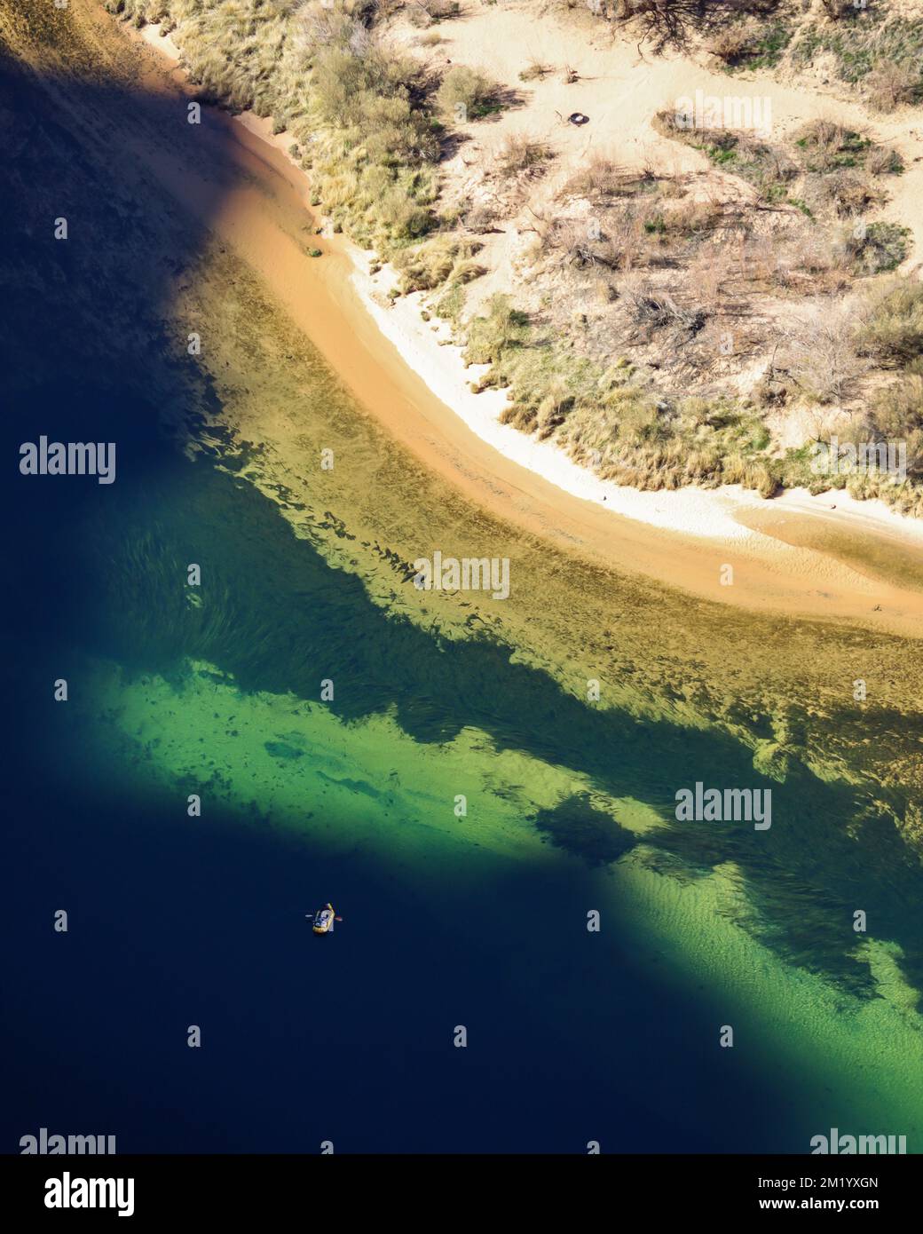 A small yellow raft floating through a the Colorado River at Horsehoe ...