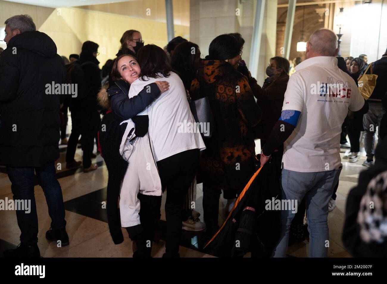 People hug, next to a temporary courtroom during the verdict’s day of ...