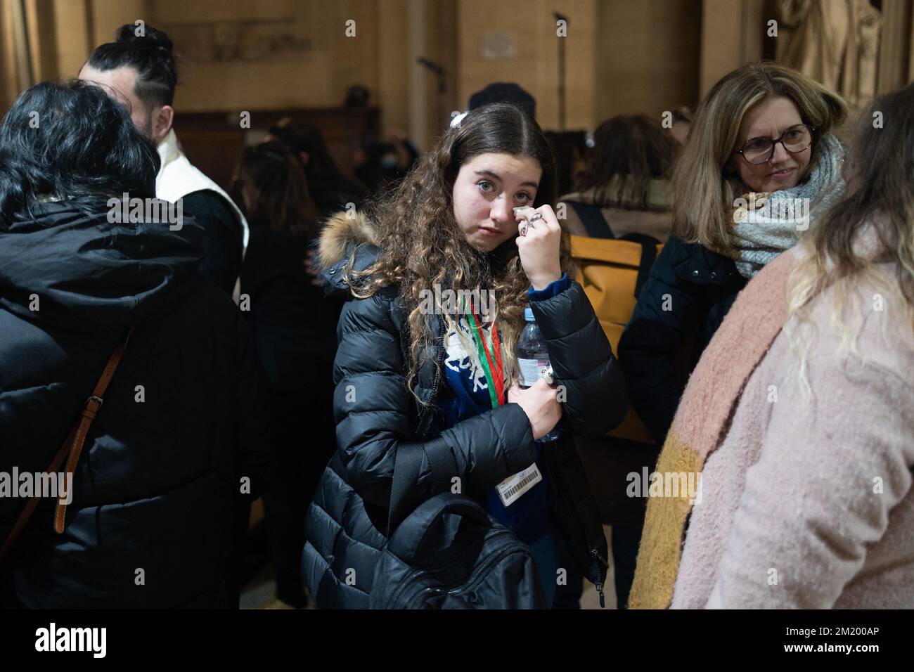 a woman cries, next to a temporary courtroom during the verdict’s day ...