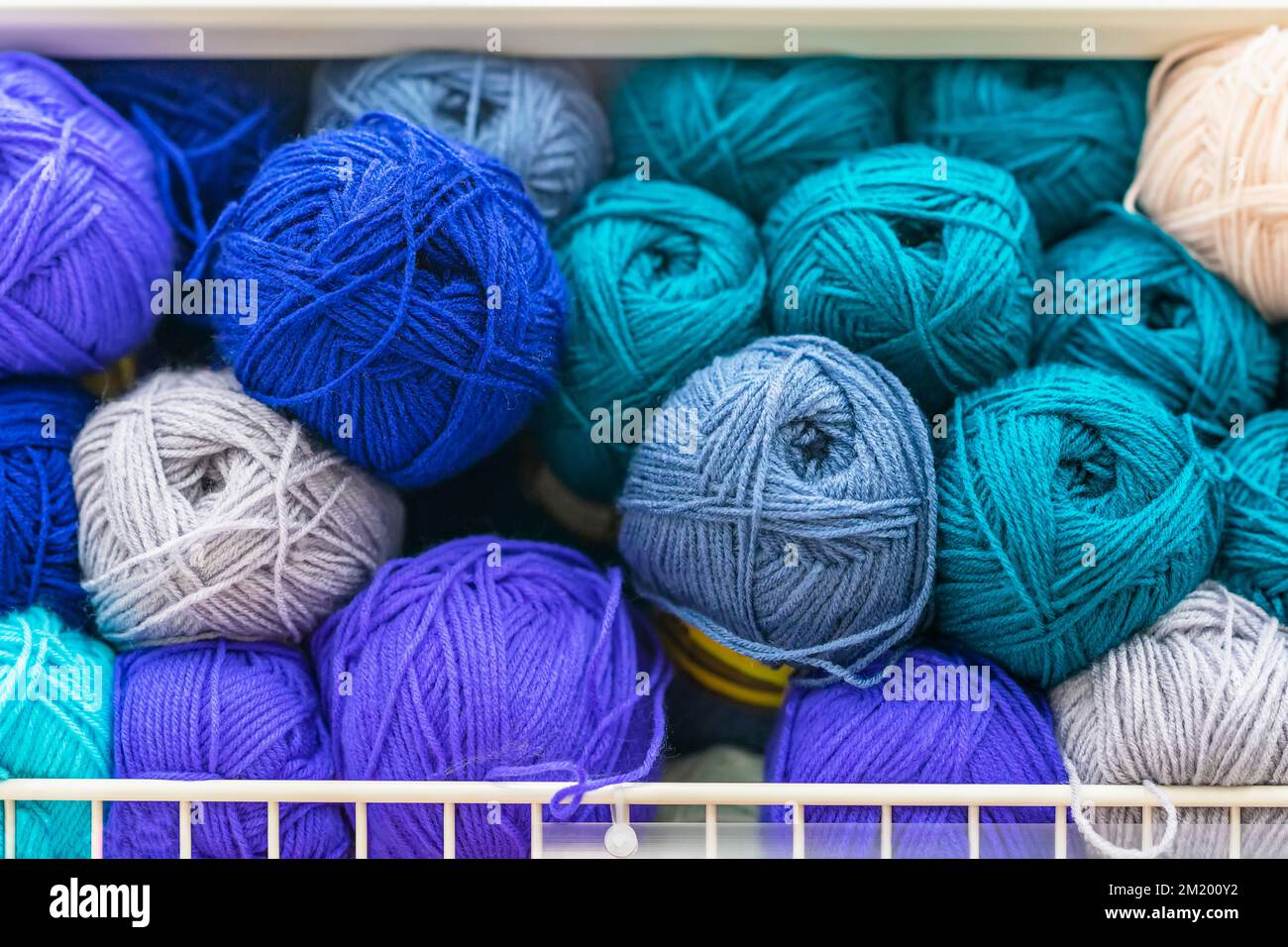 Shop shelf with blue fluffy yarn in multicolored shades. Abstract ...