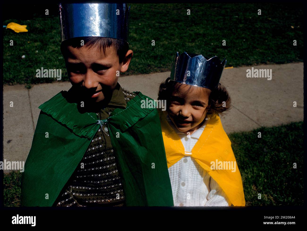 Boy and girl wearing costumes with capes and crowns, Somerville ...