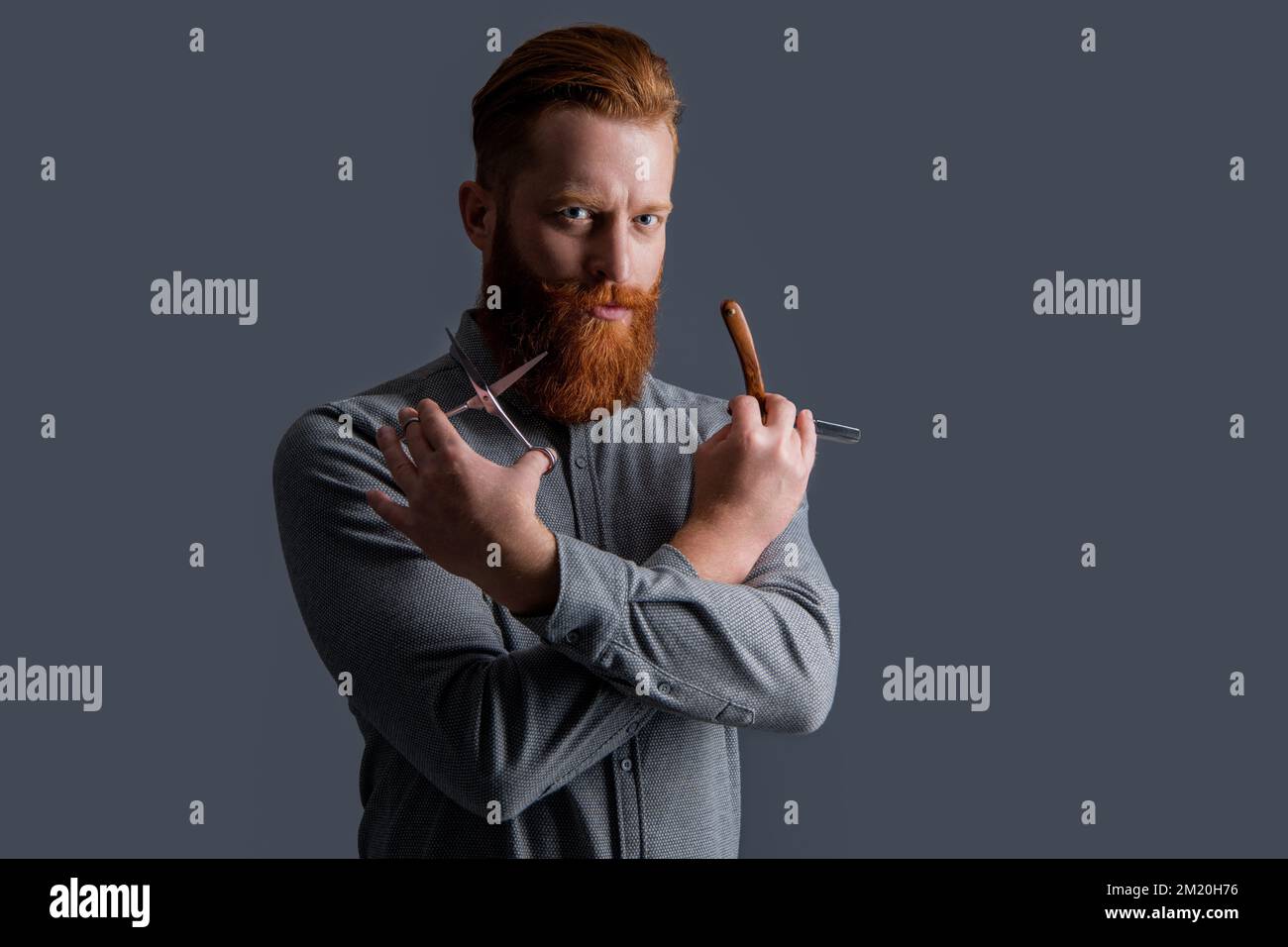 handsome barber man in barbershop studio. barber man hold scissors and ...