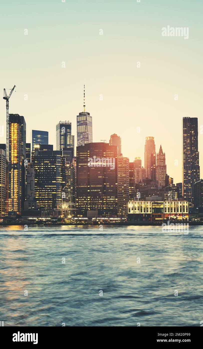 Manhattan East River waterfront silhouette at sunset, color toned ...
