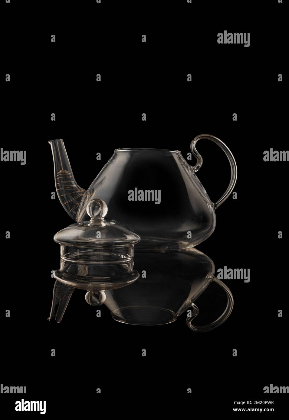 Beautiful transparent glass teapot close-up isolated on black ...