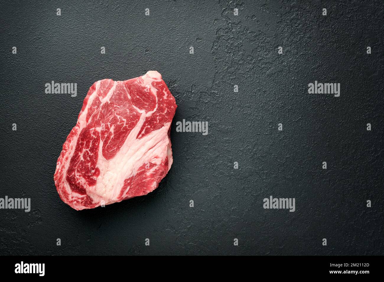 Raw beef steak. Raw fresh Chuck roll steak with rosemary, salt and ...