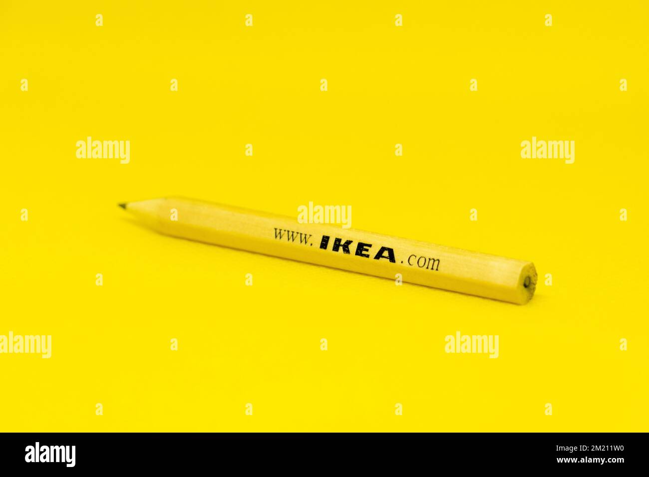 Pencil with the IKEA online shopping address isolated on orange ...