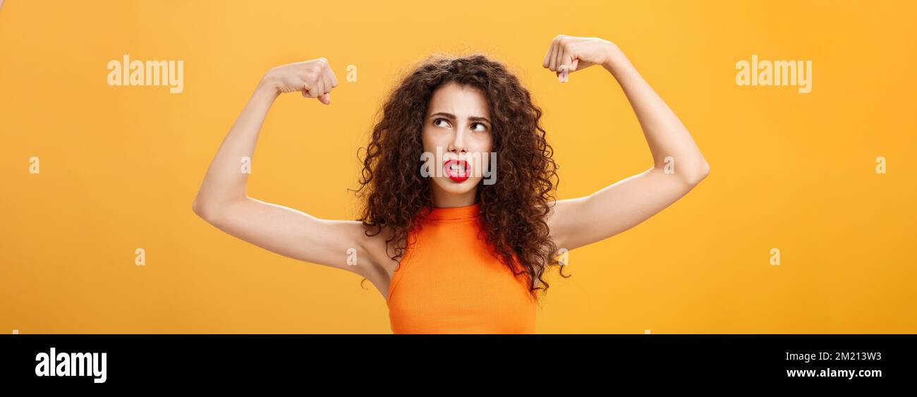 Woman feeling powerful and strong raising hands with clenched fists ...