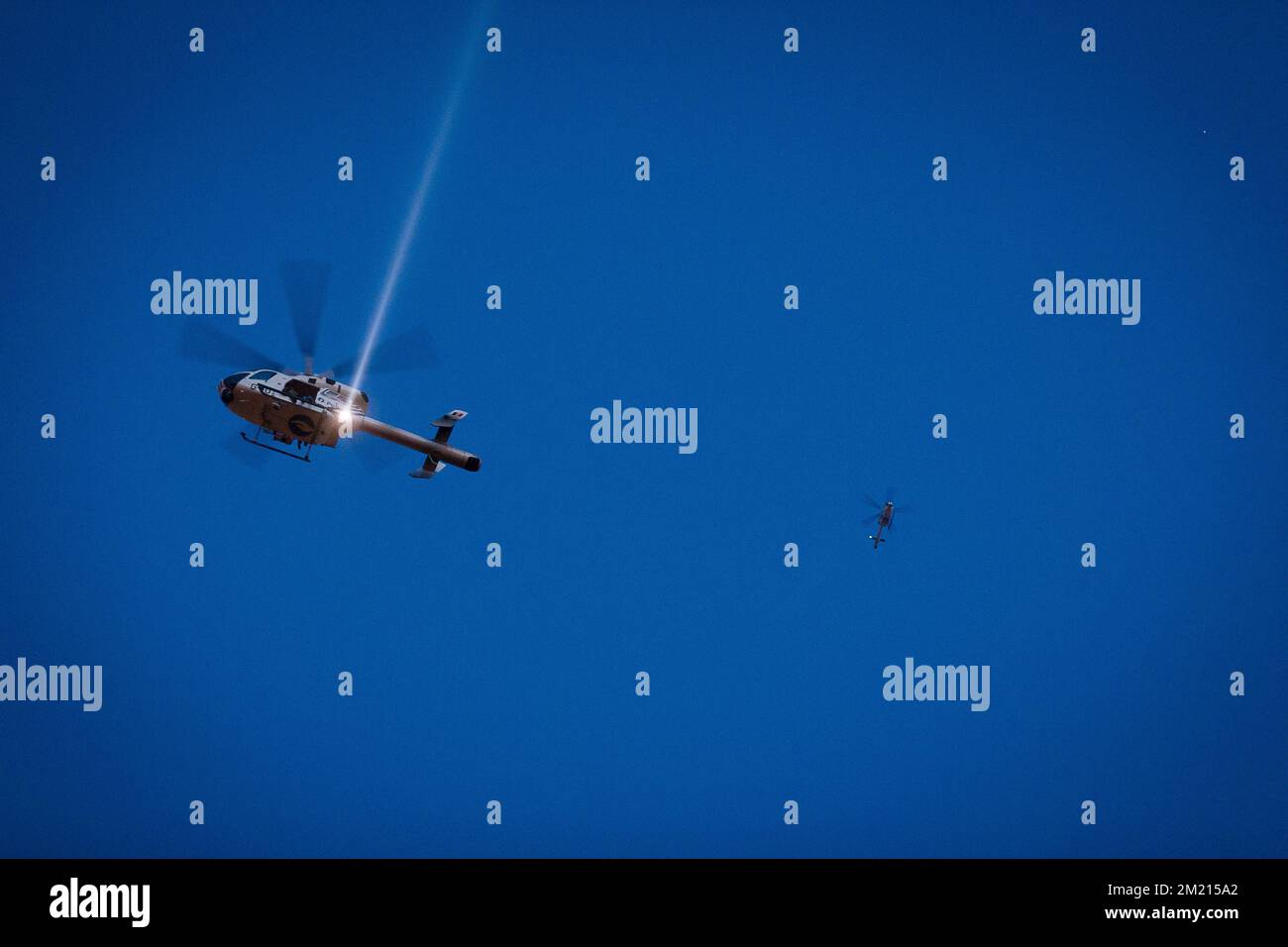 Federal police helicopter shine light on roofs as police make searches ...