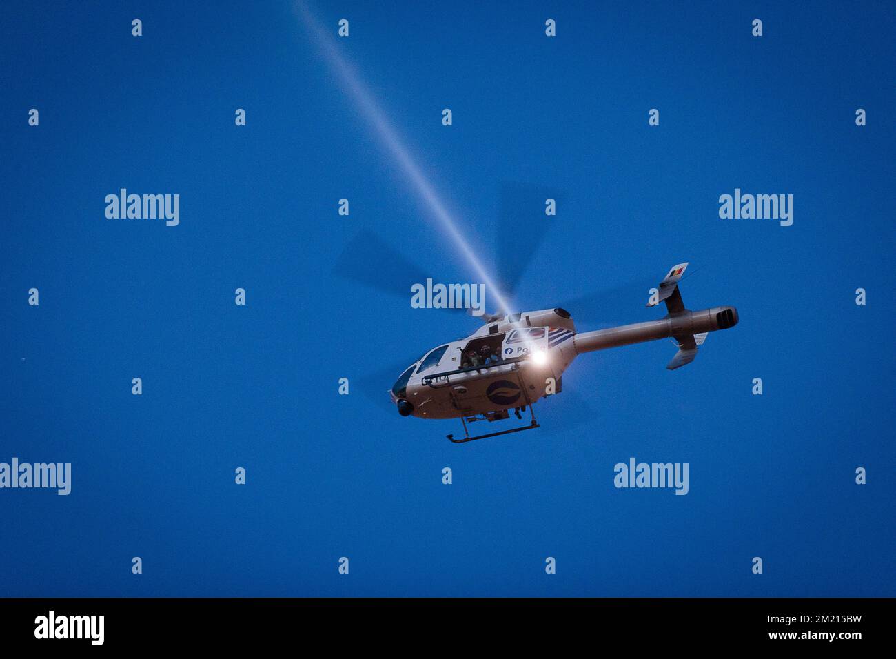 Federal police helicopter shine light on roofs as police make searches ...
