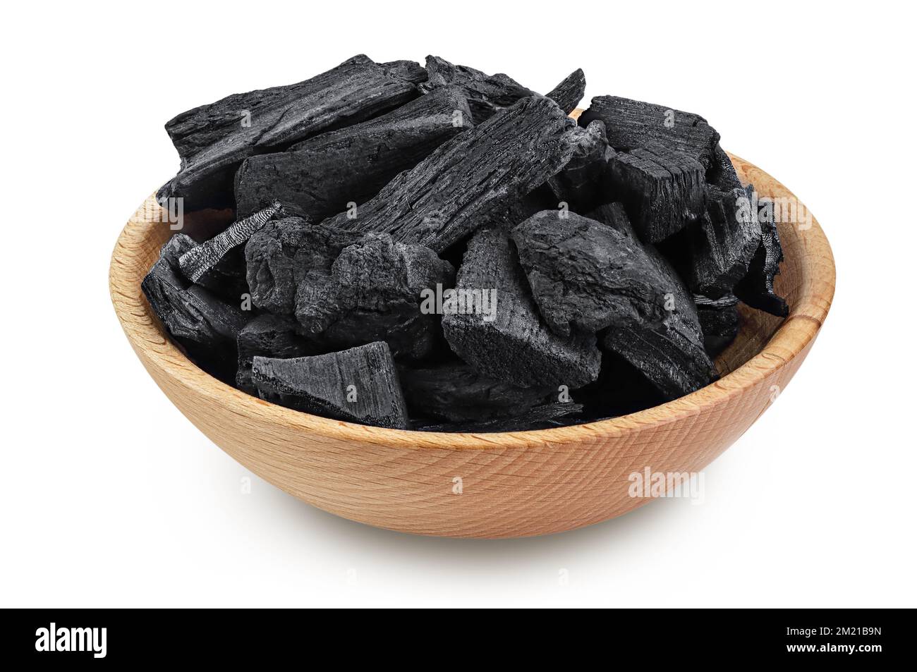 Natural charcoal in wooden bowl isolated on white background with full ...