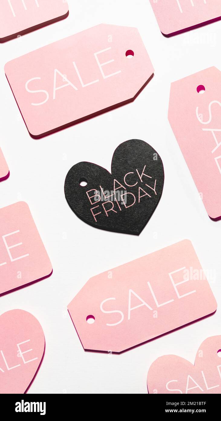 Top view on pattern of pink and black clothes tags in shape of heart on ...