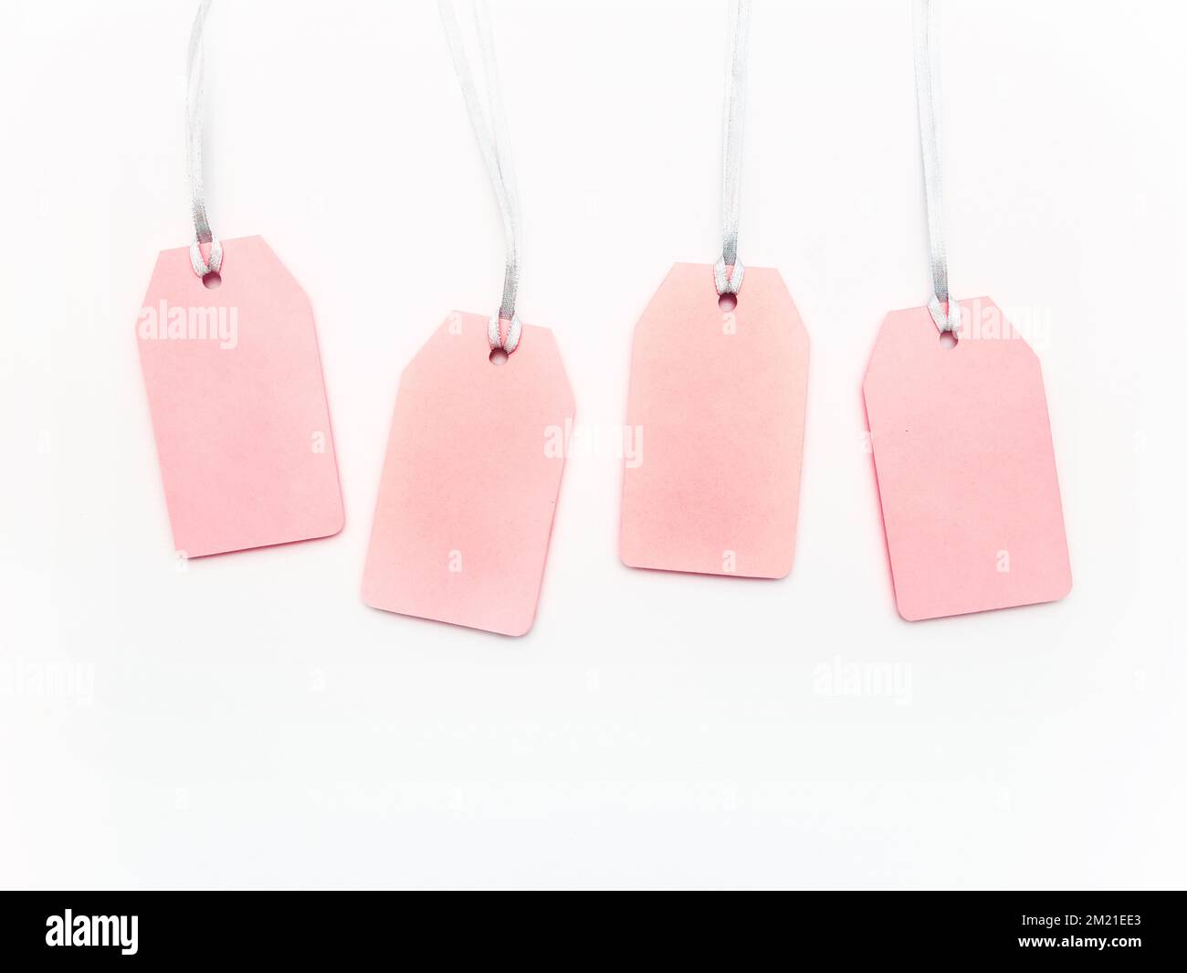Four pink clear tags on white background. Glamorous labels on silver ...