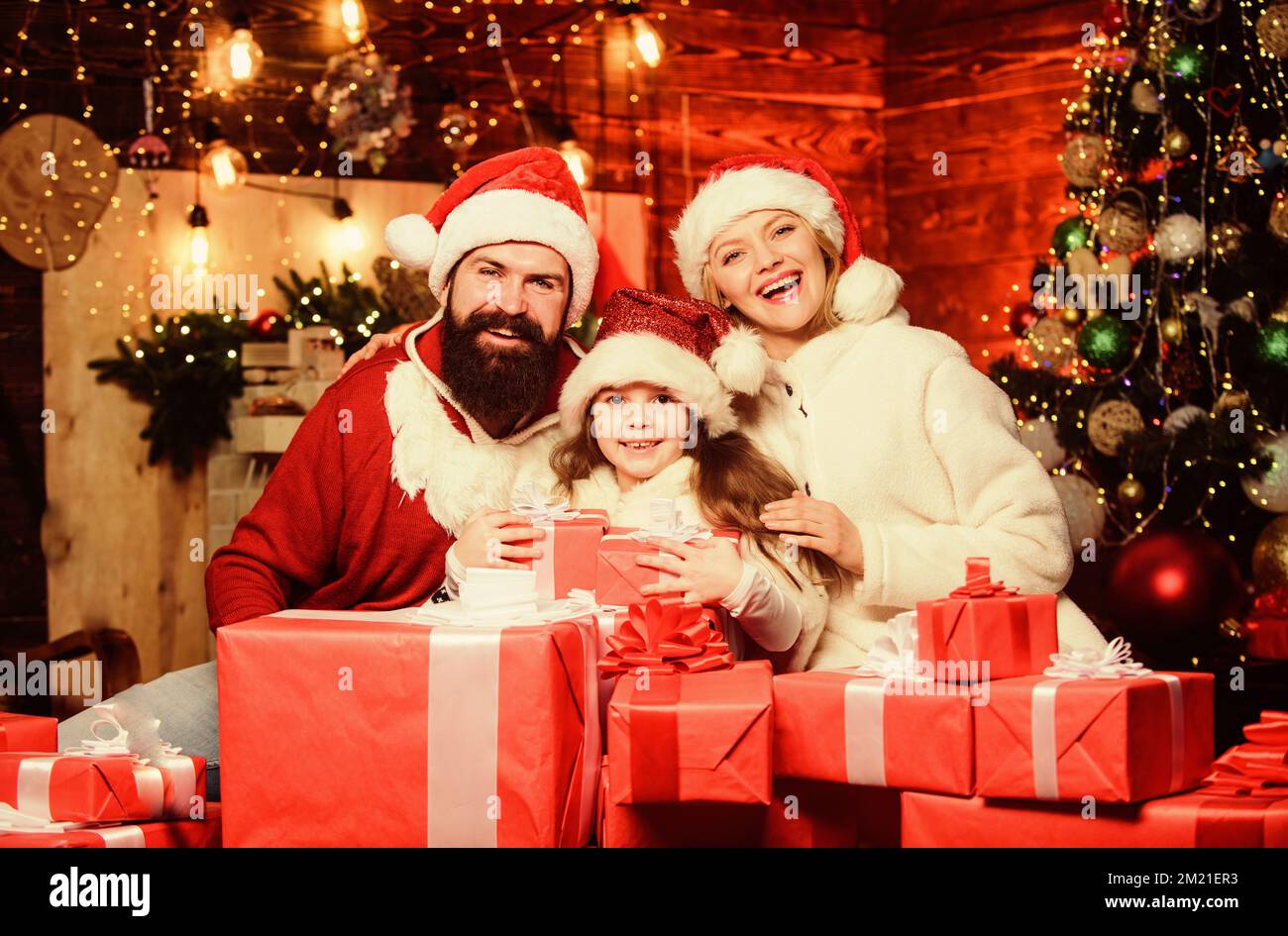 Love and kindness. Gifts from Santa. Lovely daughter with parents ...