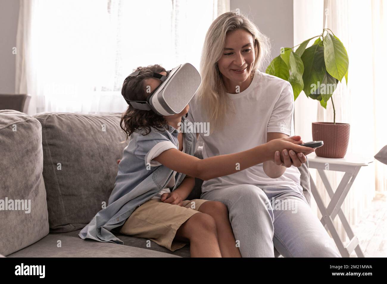 boy kid wearing virtual reality headset with his mother vr glasses in ...