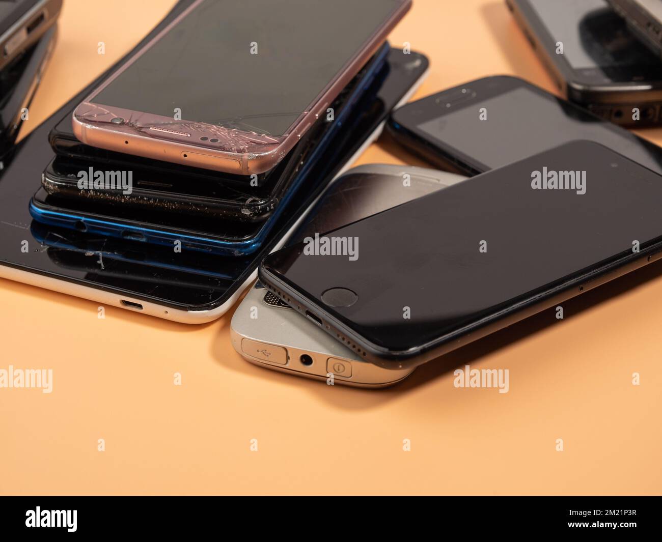 Lots of old smartphones on an orange background. Old mobile phones ...