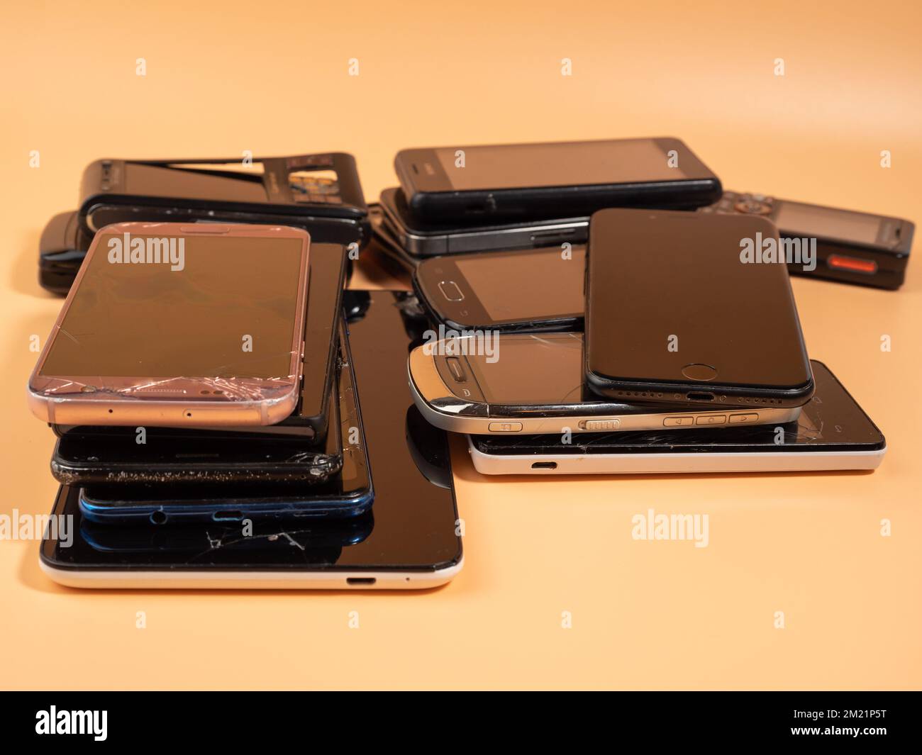 Lots of old smartphones on an orange background. Old mobile phones ...