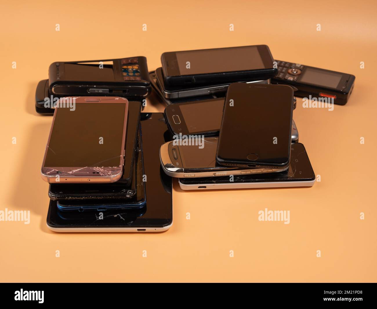 Lots of old smartphones on an orange background. Old mobile phones ...