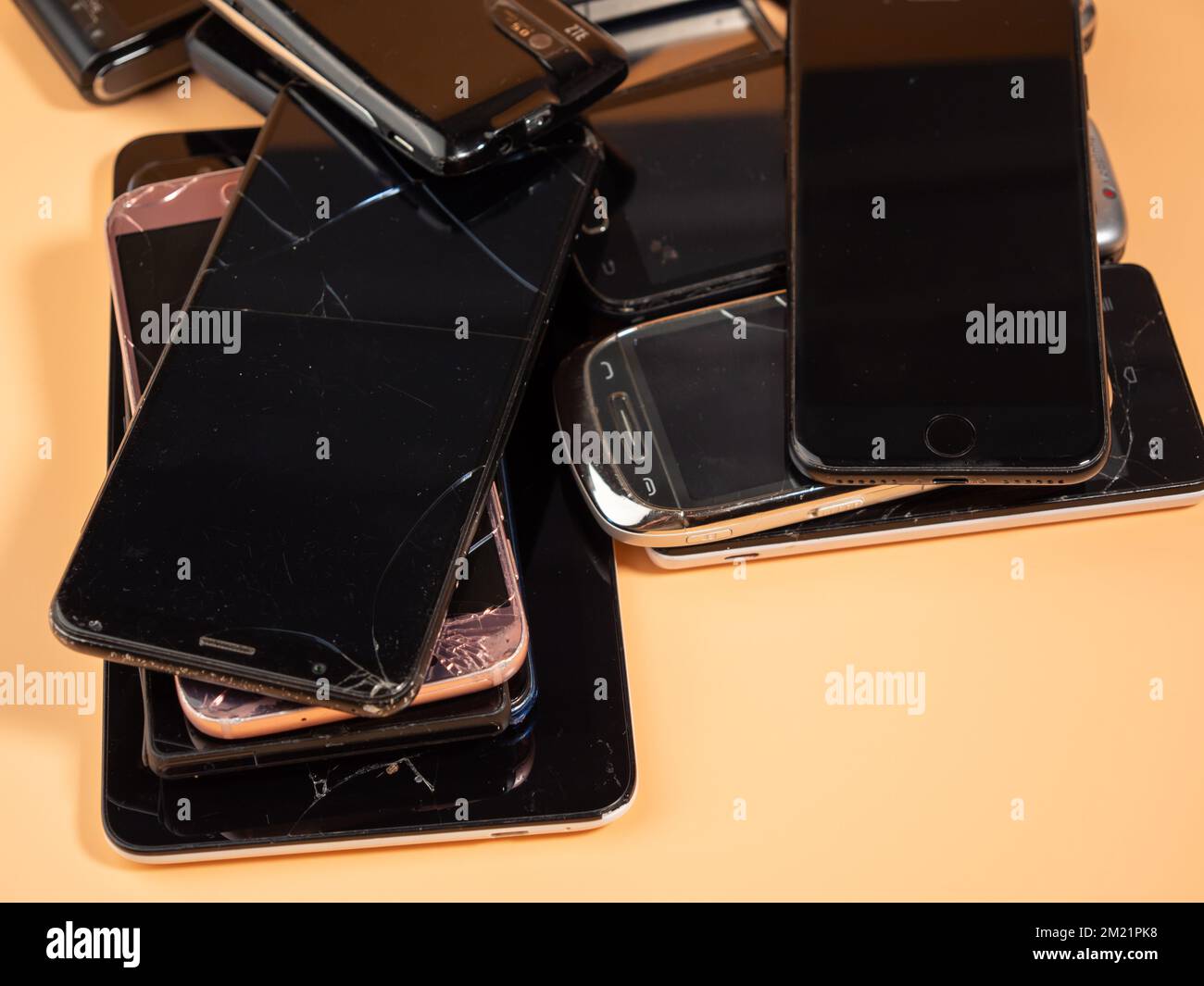 Lots of old smartphones on an orange background. Old mobile phones ...