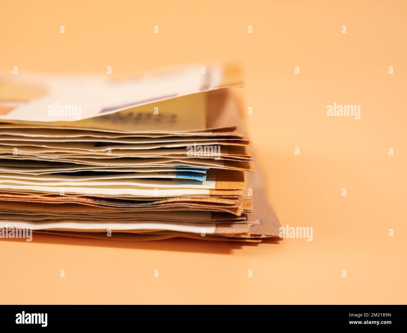 Money on an orange background. Euro paper banknotes. Close-up Stock ...