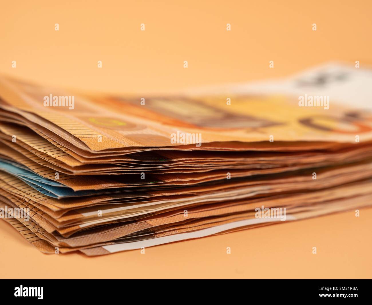 Money on an orange background. Euro paper banknotes. Close-up Stock ...