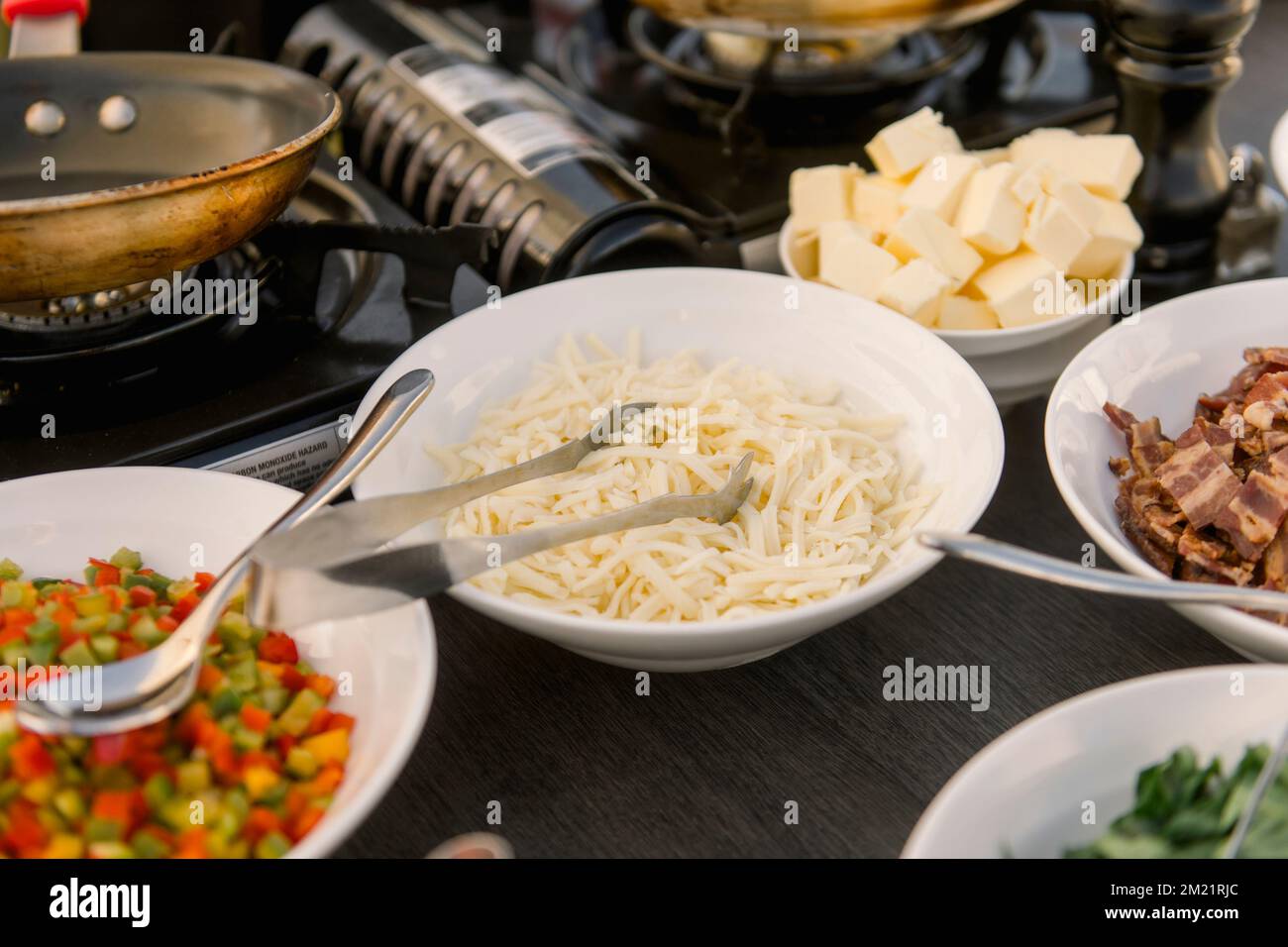 A closeup shot of bowls of toppings like cheese for homemade tacos ...
