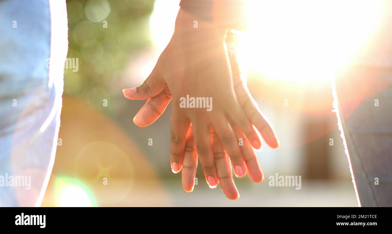 Black couple holding hands outside during golden hour time sunset Stock ...