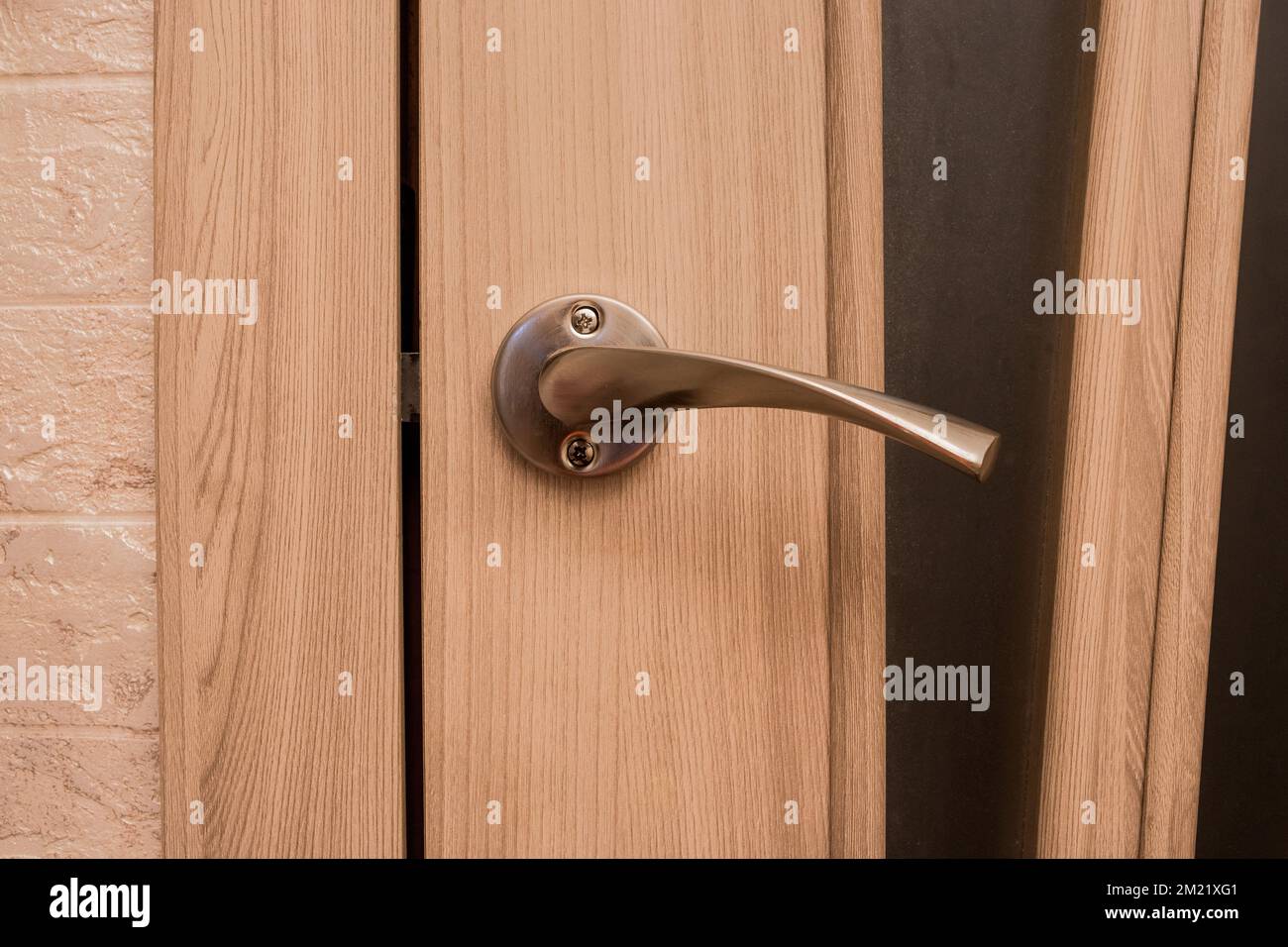 A metal handle of a wooden door of a residential room home interior ...