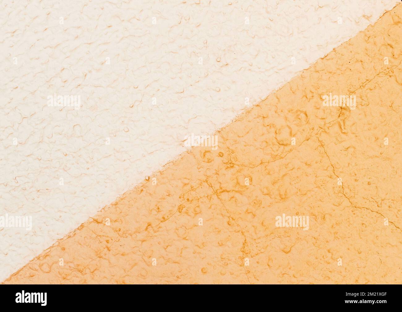 Diagonal line on a sand plaster wall with two colors - light yellow and ...