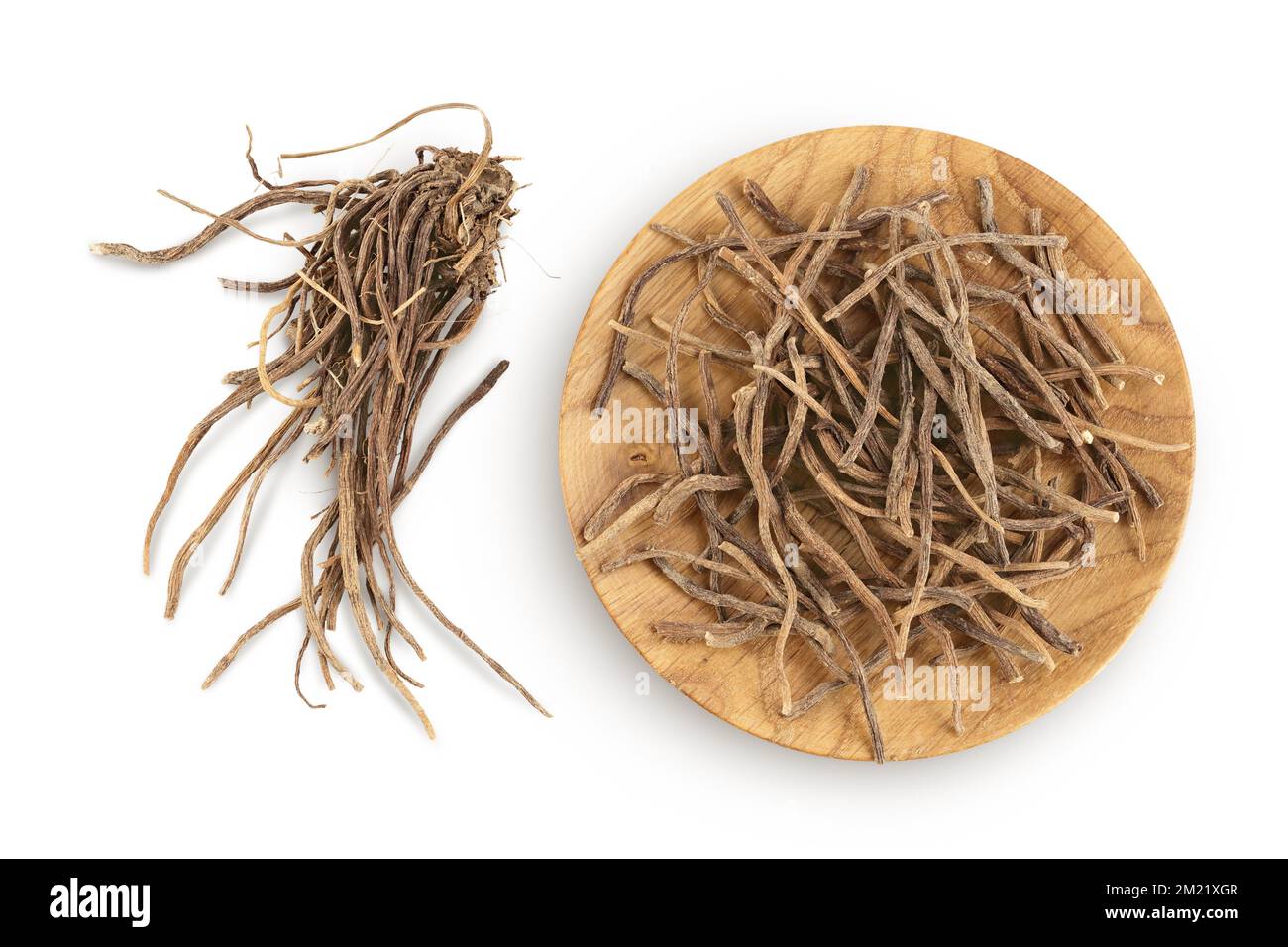 Dried Valerian root in wooden bowl isolated on white background ...