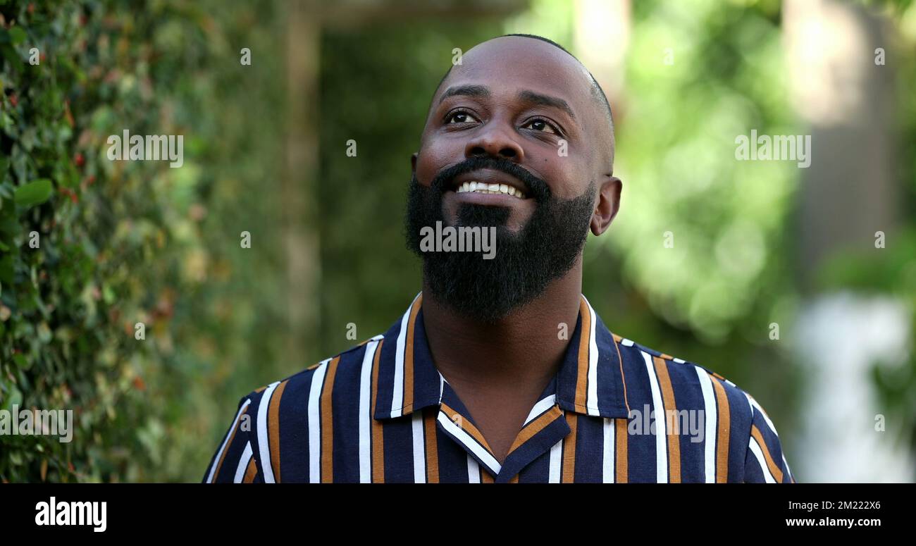 Happy black African person standing outside smiling Stock Photo - Alamy