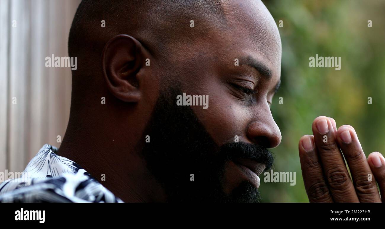 Happy optimistic black African man smiling looking at sky with HOPE and ...