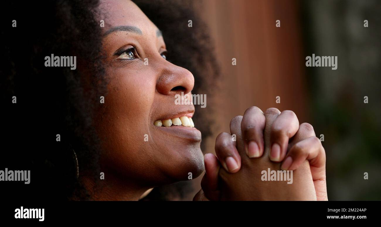 Happy smiling African woman feeling HOPE and FAITH Stock Photo - Alamy