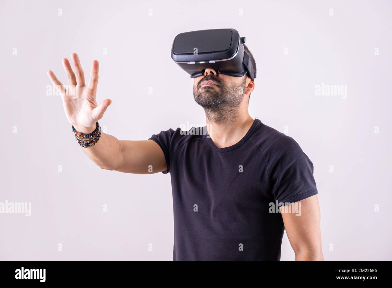 Young man in VR glasses headset gesturing portrait. Virtual reality ...