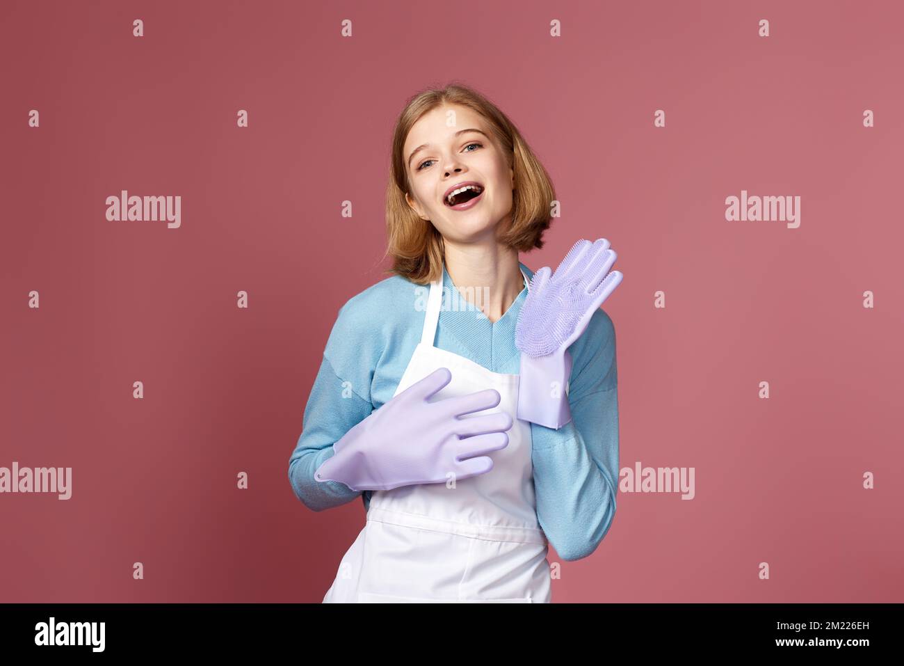 woman in gloves and cleaner apron on pink background Stock Photo - Alamy