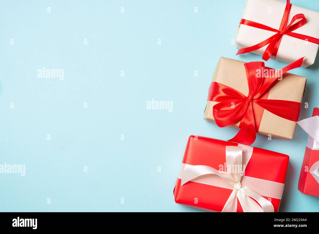 Christmas presents on blue background top view Stock Photo - Alamy