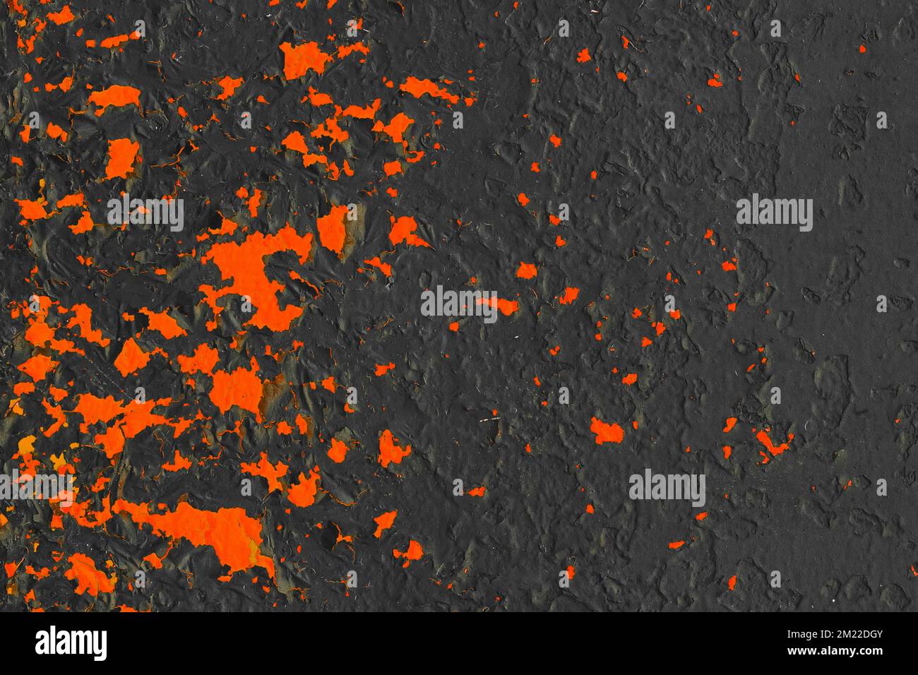 Orange painted dark metal surface with old brown peeling paint pattern ...