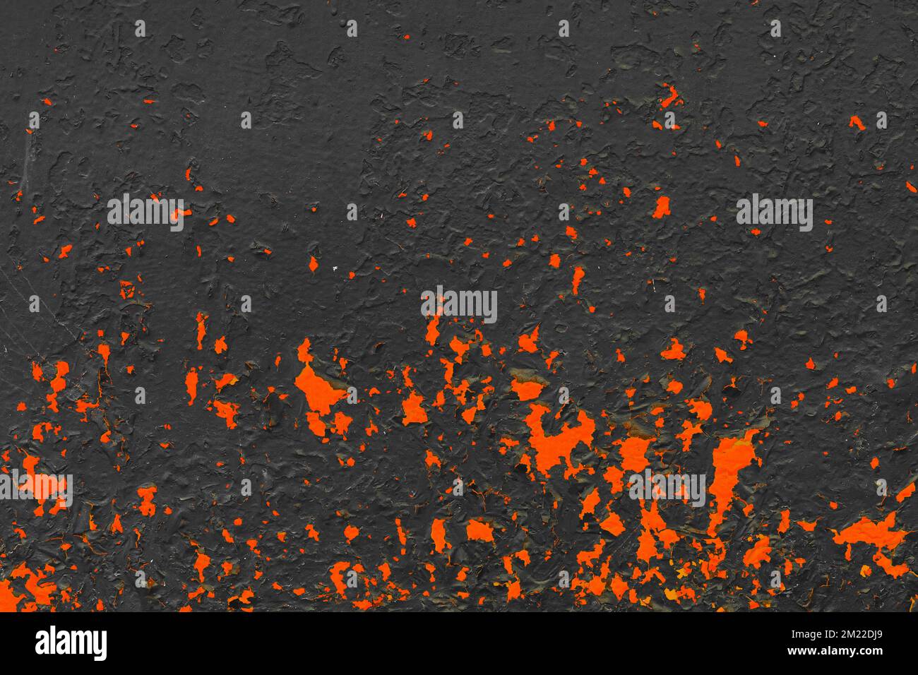Orange painted dark metal surface with old brown peeling paint pattern ...