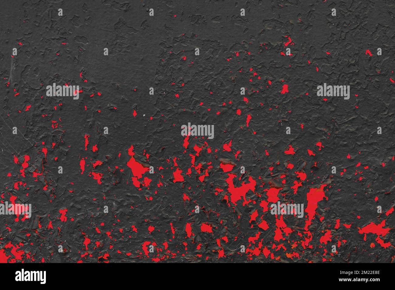 Black painted dark metal surface with old red blood color peeling paint ...